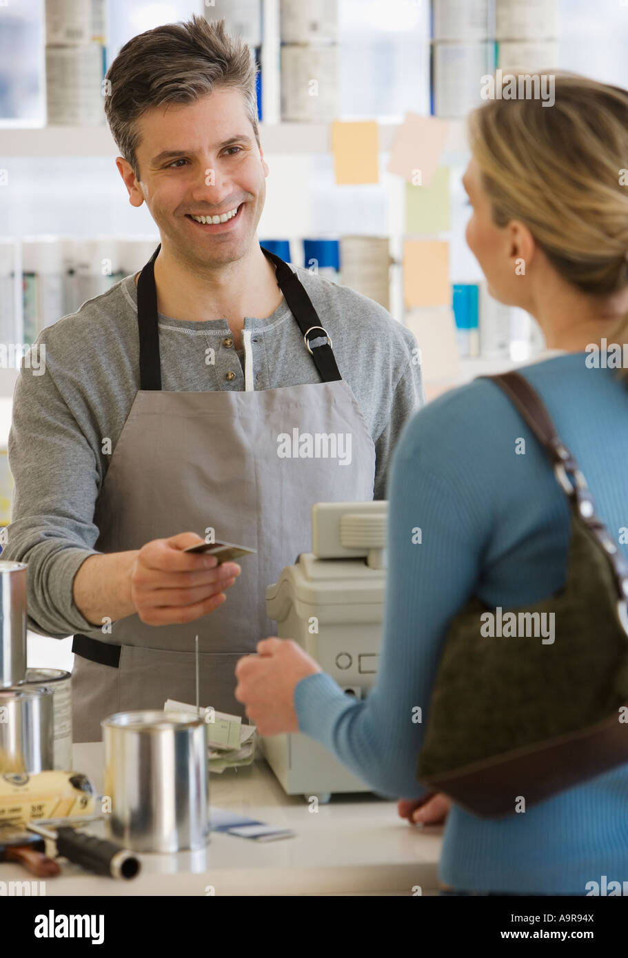 Woman shopping paying cashier clothes hi-res stock photography and ...