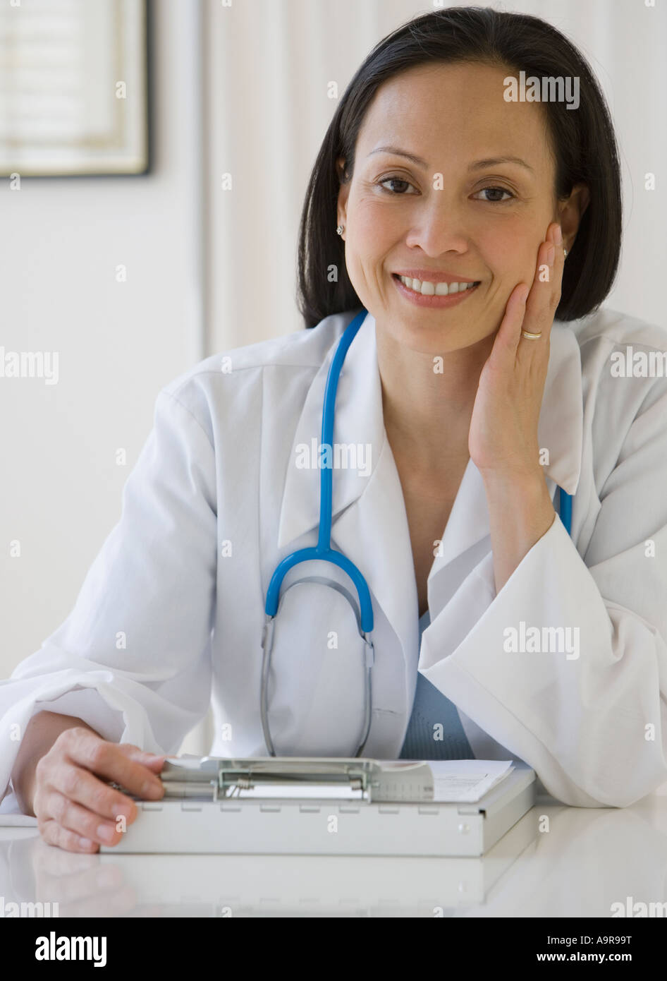 Female doctor sitting desk head hi-res stock photography and images - Alamy