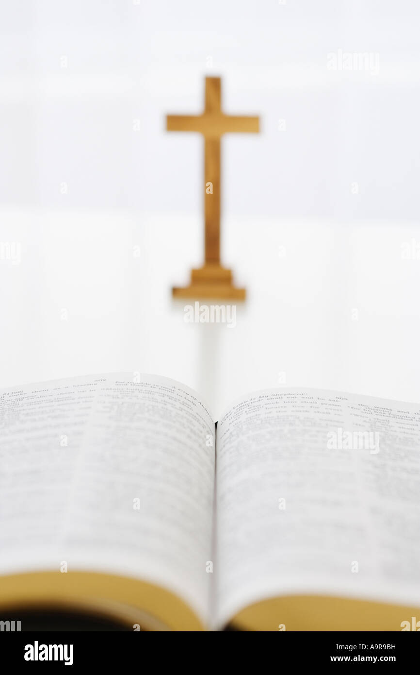 Open book and cross in background Stock Photo - Alamy
