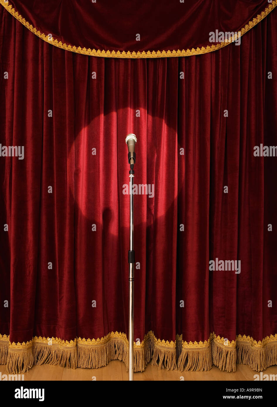 Spotlight on microphone on stage Stock Photo - Alamy