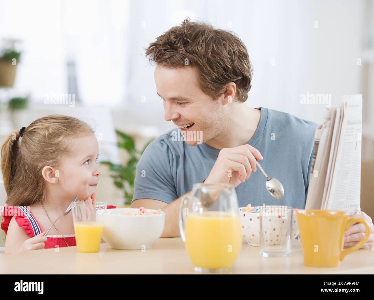 Father and daughter eating breakfast Stock Photo - Alamy