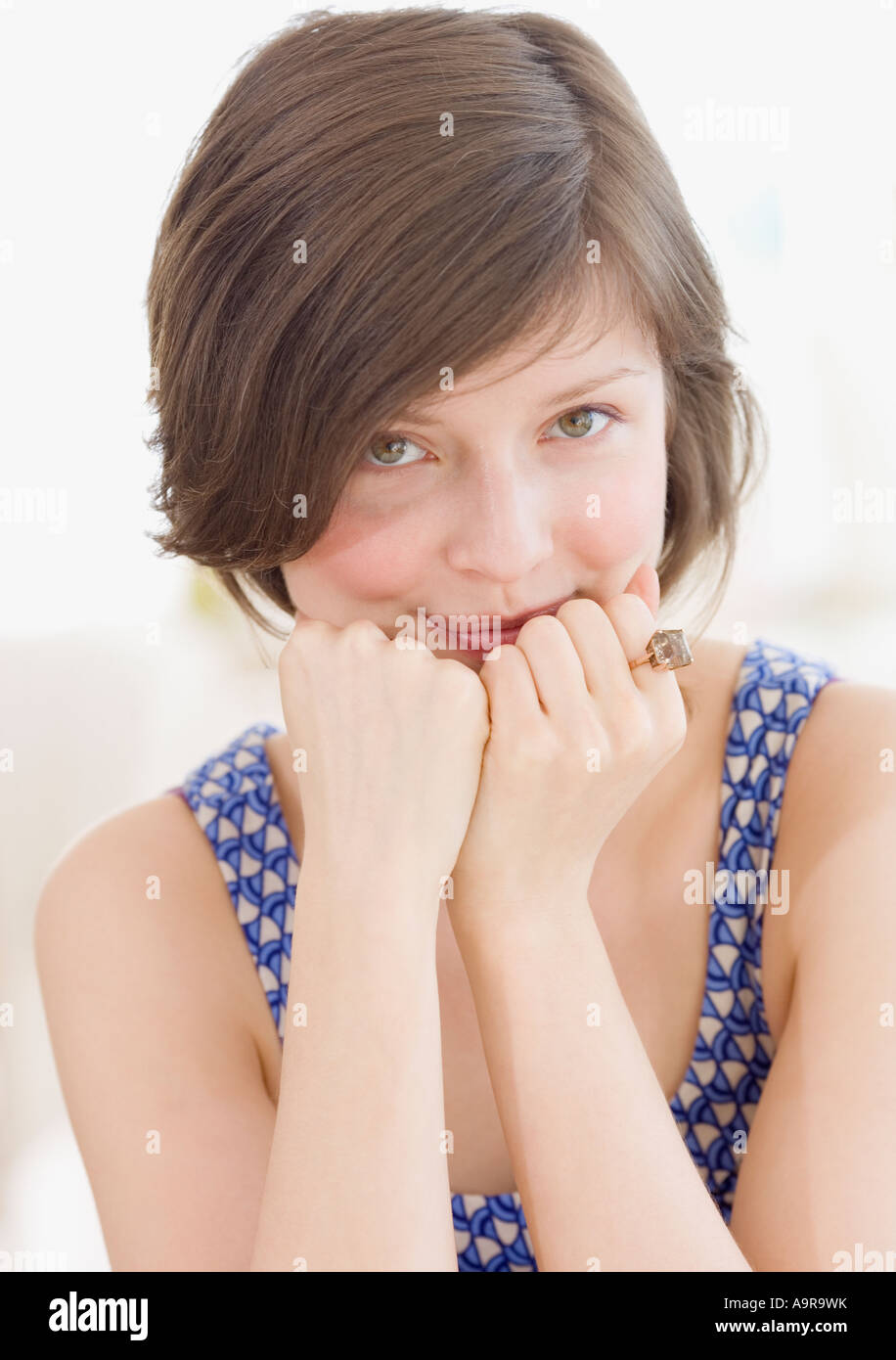 Woman leaning chin on hands Stock Photo - Alamy