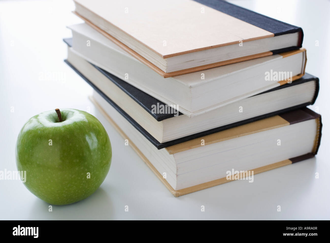 Stack of books and apple Stock Photo - Alamy