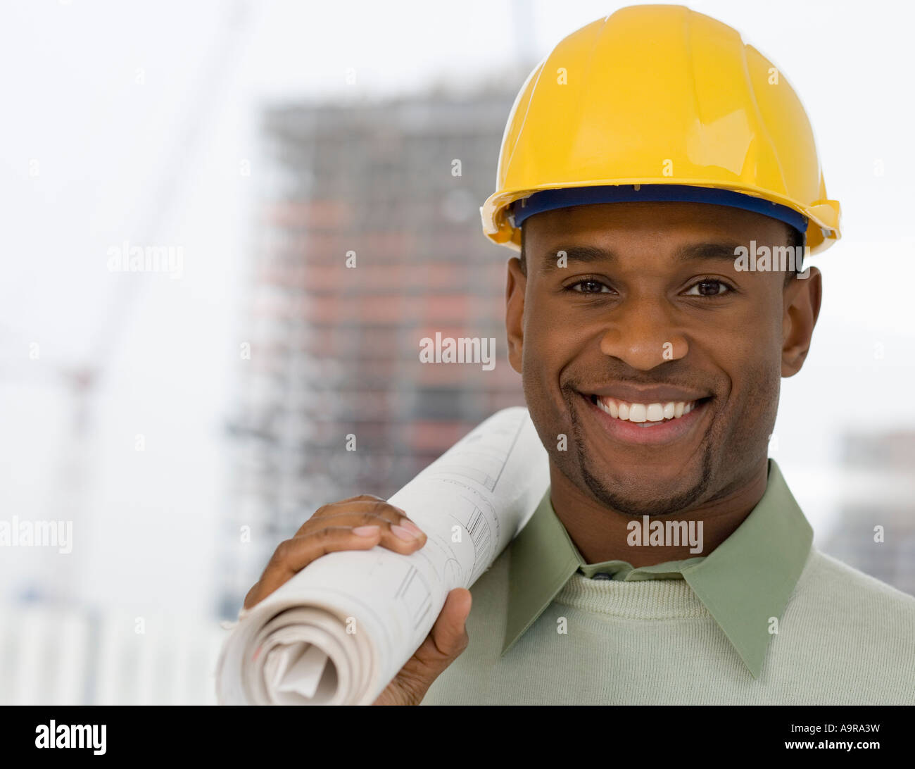 Portrait of man in hard hat holding blueprints Stock Photo - Alamy