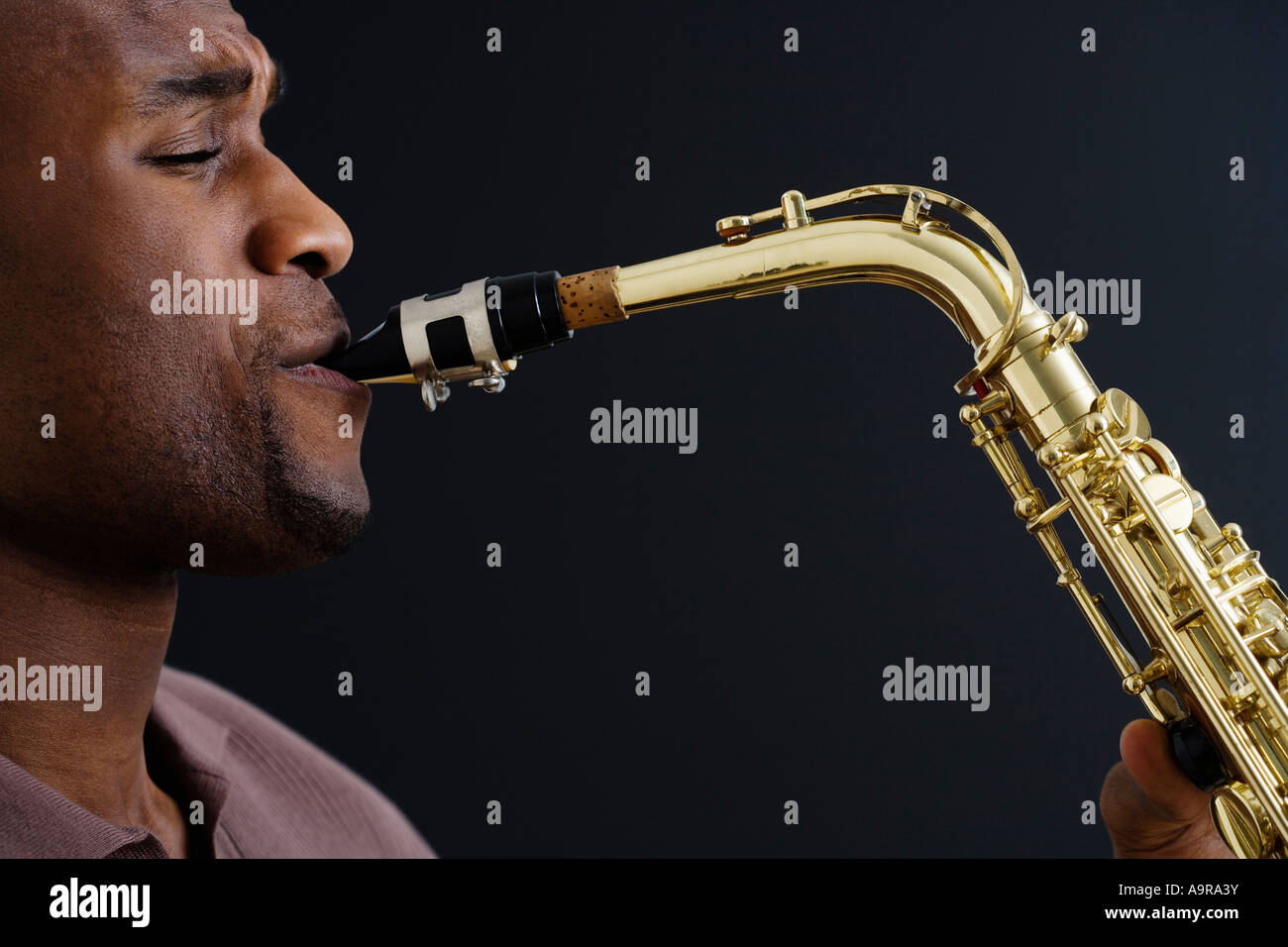 Close up of man playing saxophone Stock Photo - Alamy