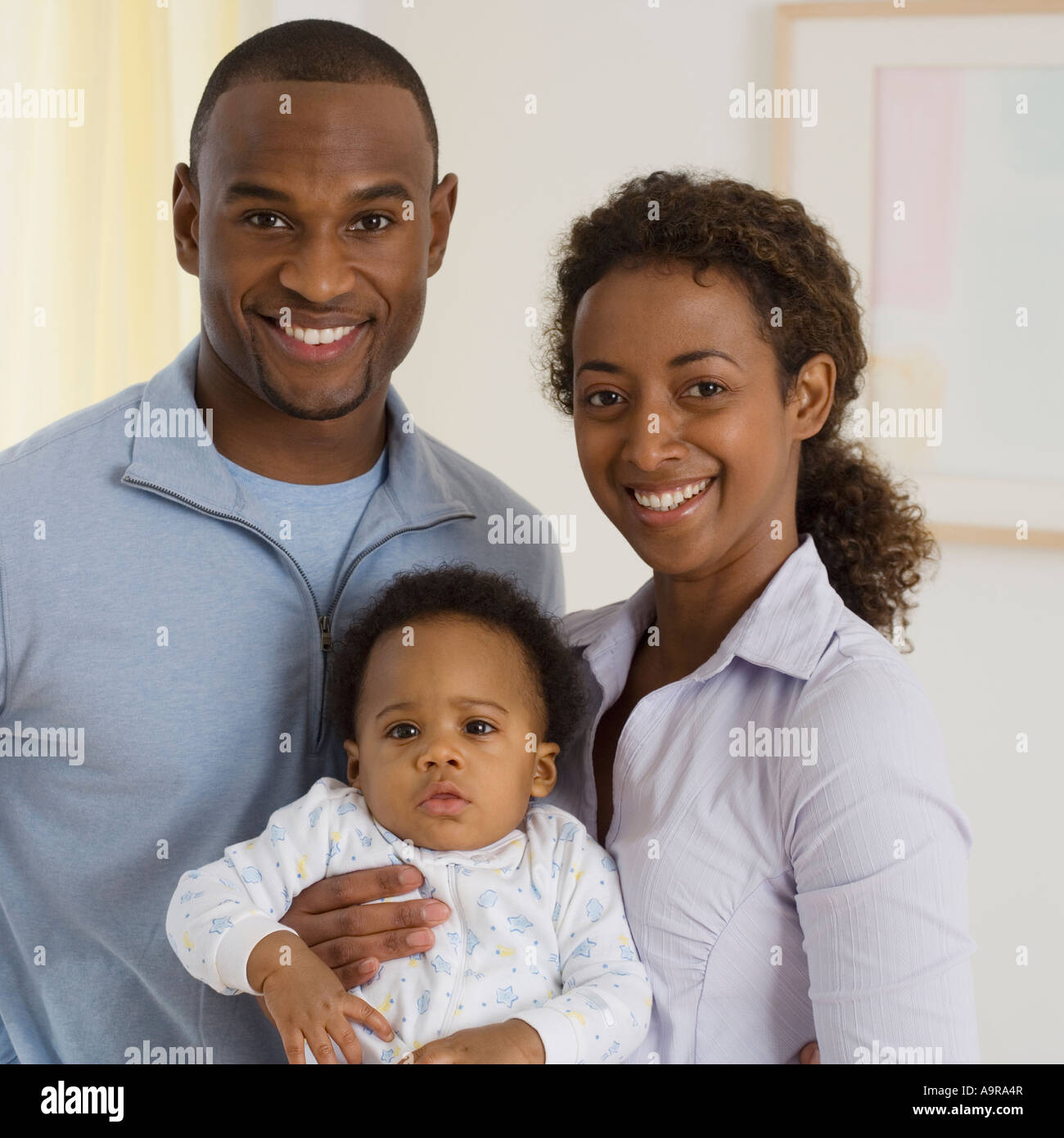 Portrait of parents holding baby Stock Photo - Alamy