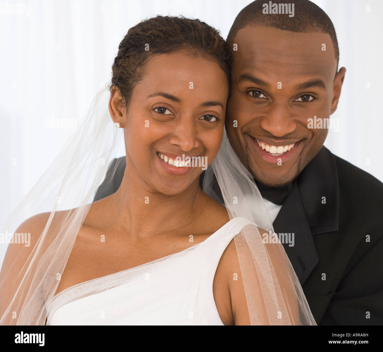 Portrait of bride and groom hugging Stock Photo - Alamy