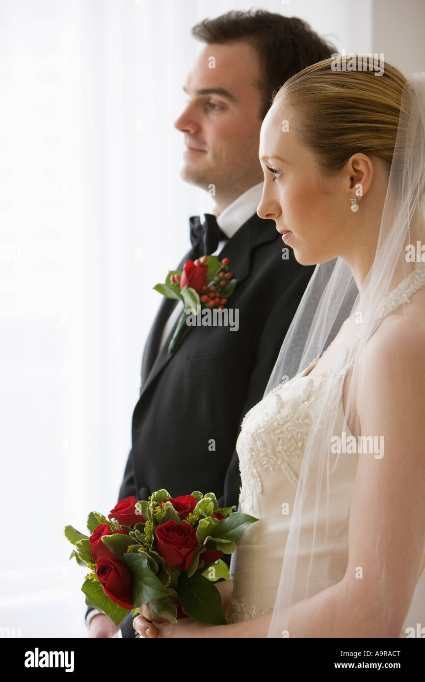 Bride and groom standing next to each other Stock Photo - Alamy