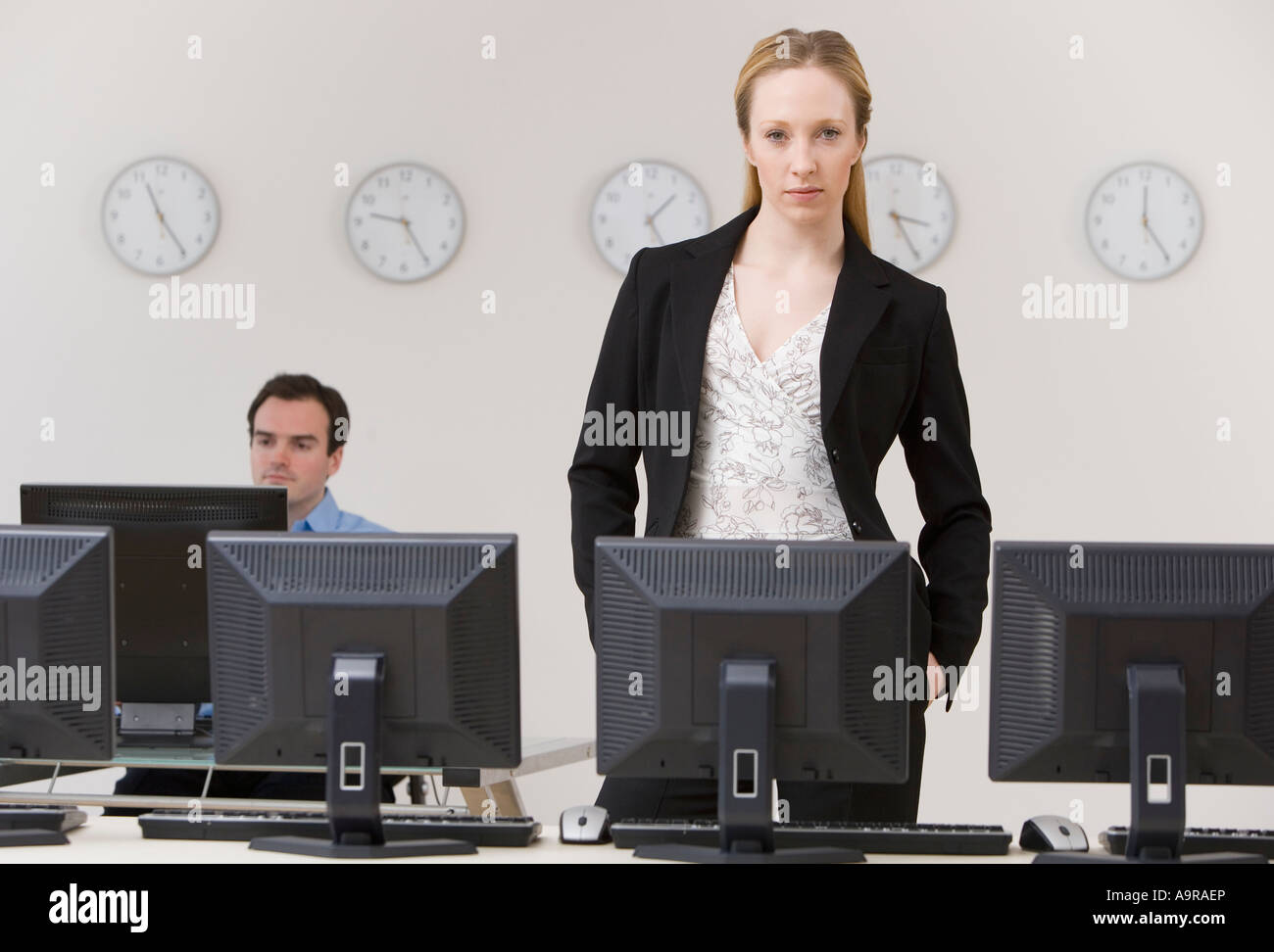Businesswoman behind row of computers Stock Photo - Alamy