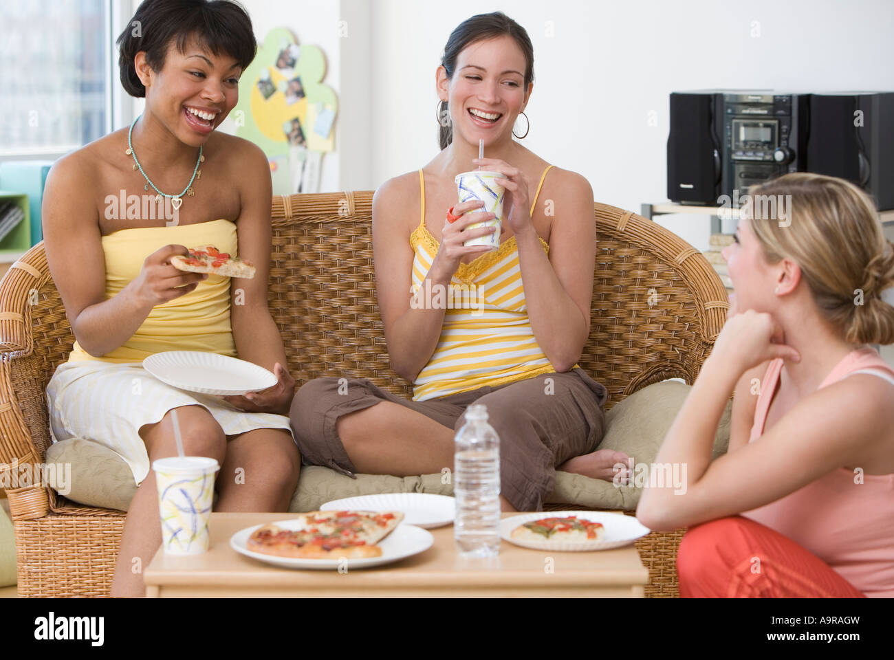 Multi ethnic women eating pizza Stock Photo - Alamy