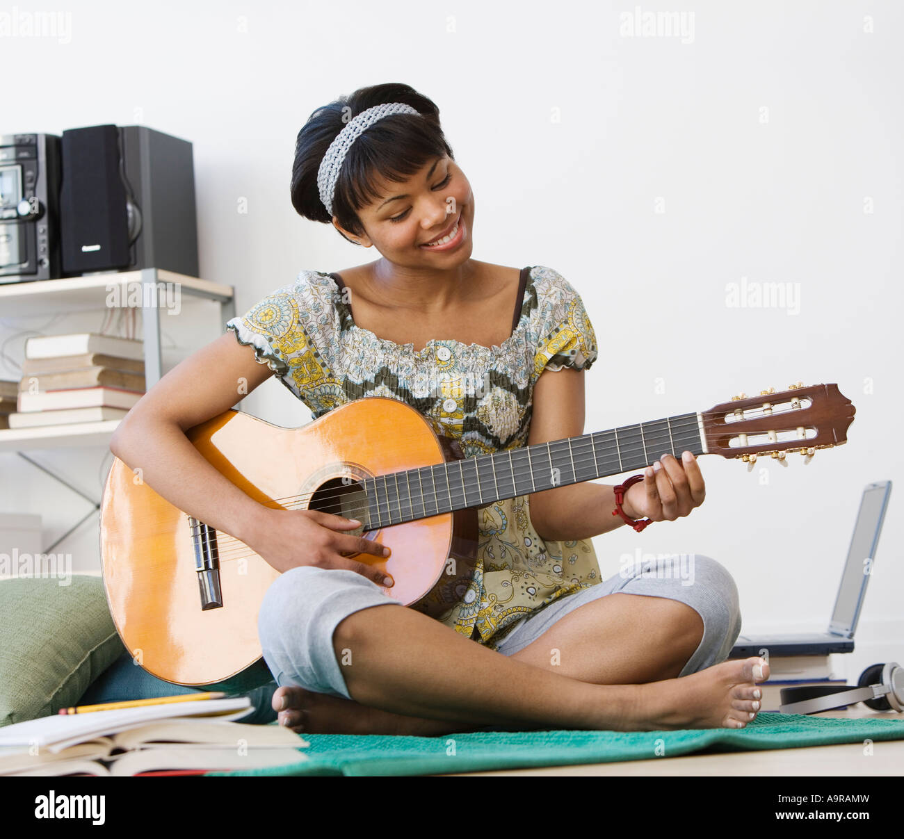 Seated woman playing hi-res stock photography and images - Alamy