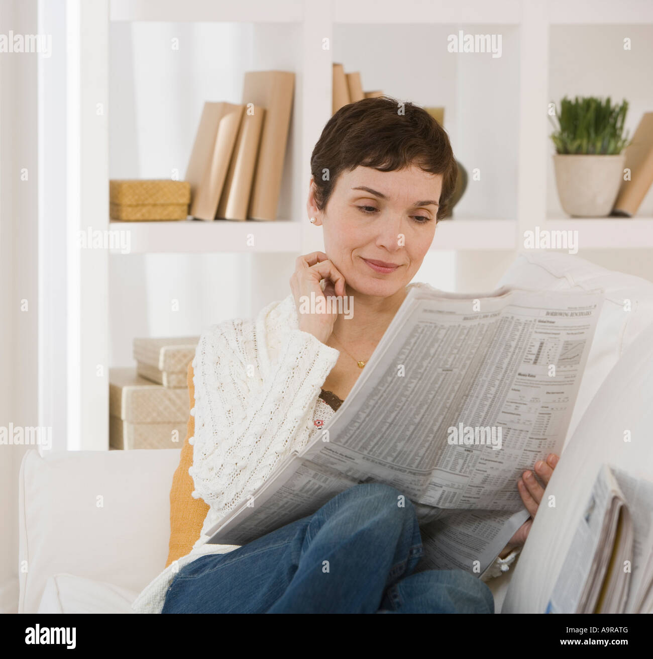 Woman reading newspaper Stock Photo - Alamy