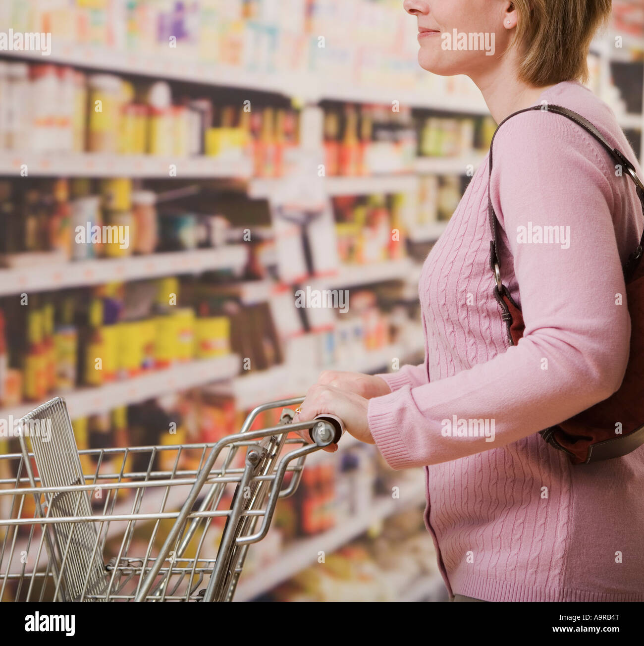 Woman pushing shopping cart side view hi-res stock photography and ...