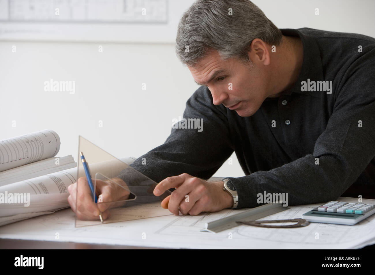 Male architect working at desk Stock Photo - Alamy
