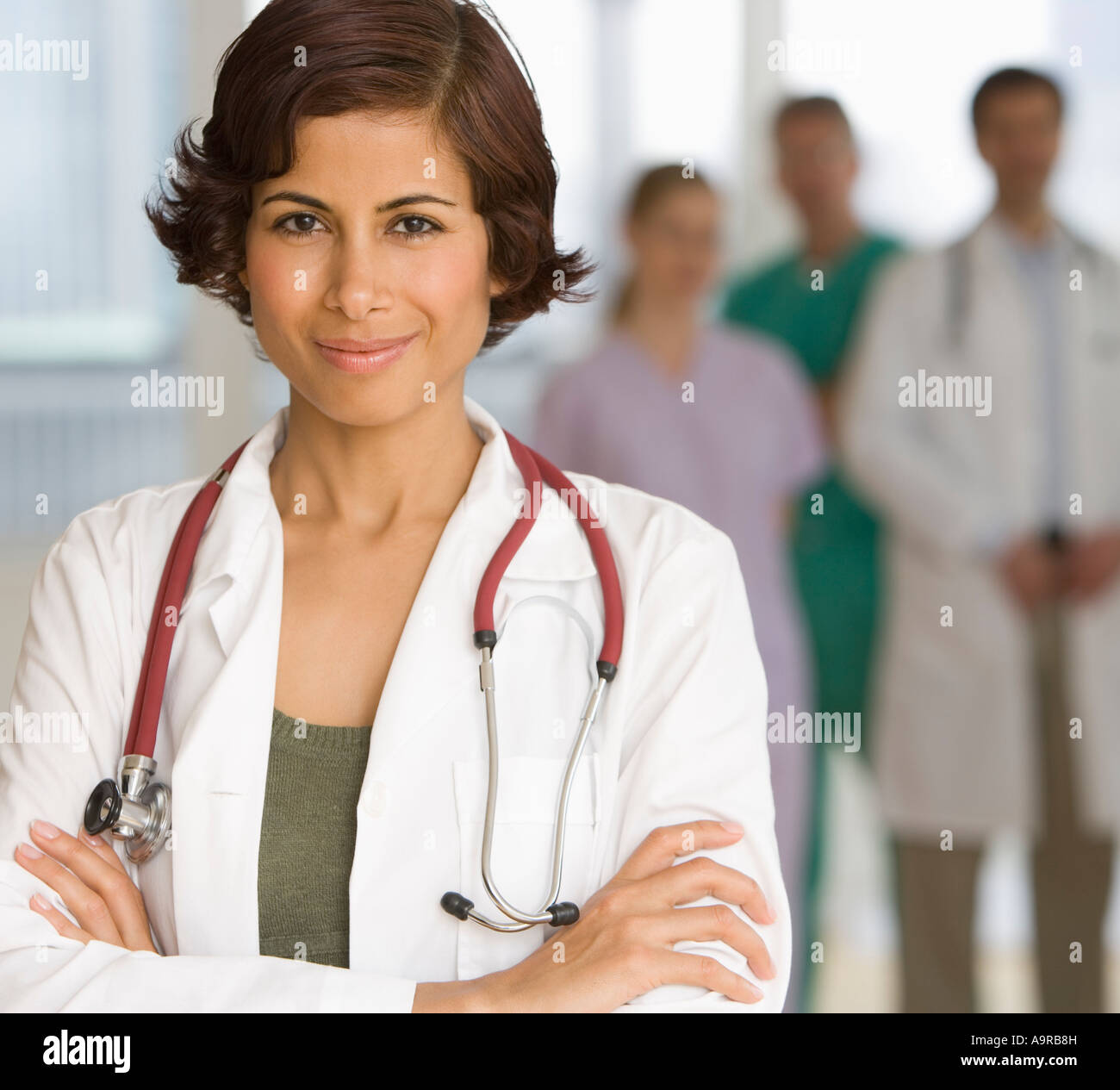 Female doctor with arms crossed Stock Photo - Alamy