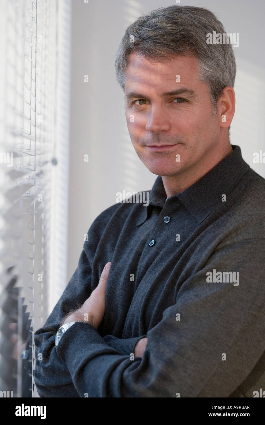 Man standing next to window Stock Photo - Alamy