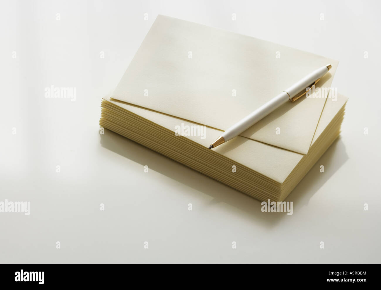 Stack of note paper and pen Stock Photo - Alamy