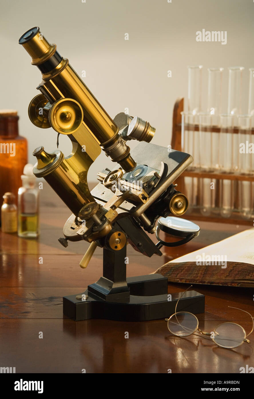 Old fashioned microscope on table Stock Photo - Alamy
