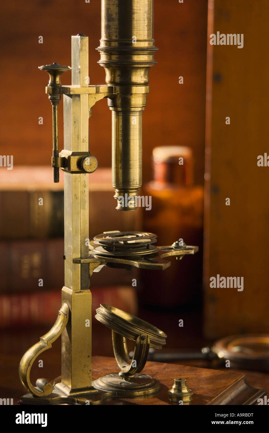 Old fashioned microscope on table Stock Photo - Alamy