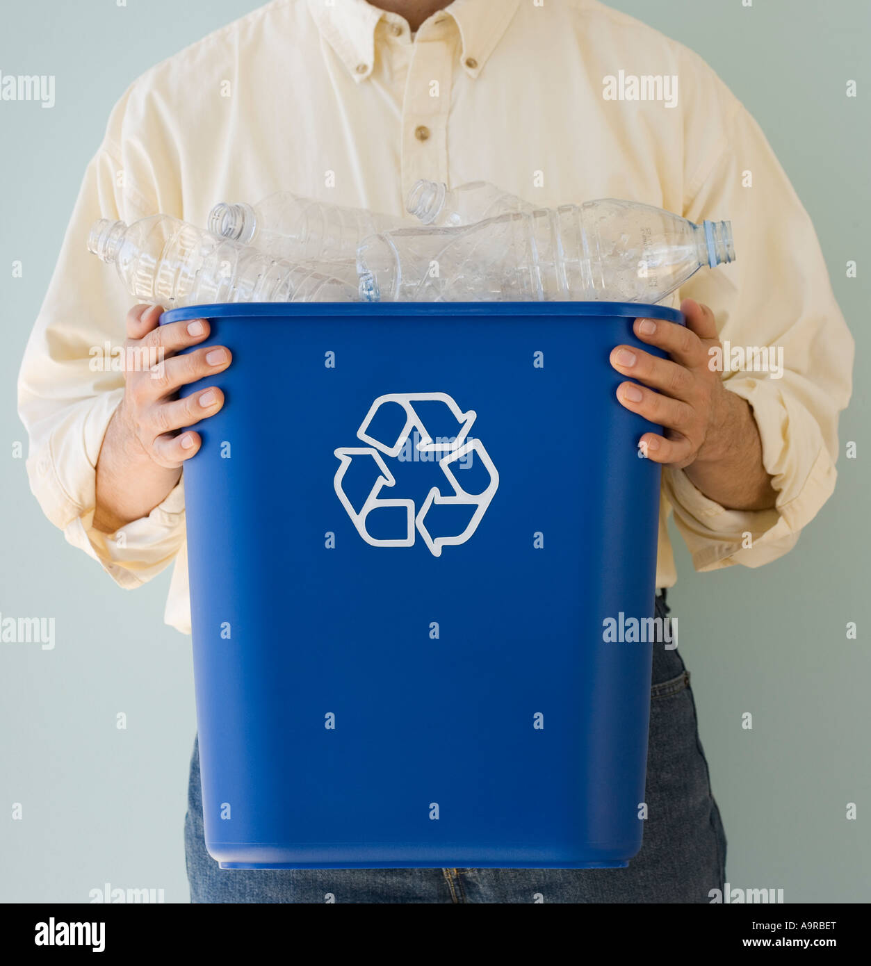 Man holding recycling bin Stock Photo - Alamy