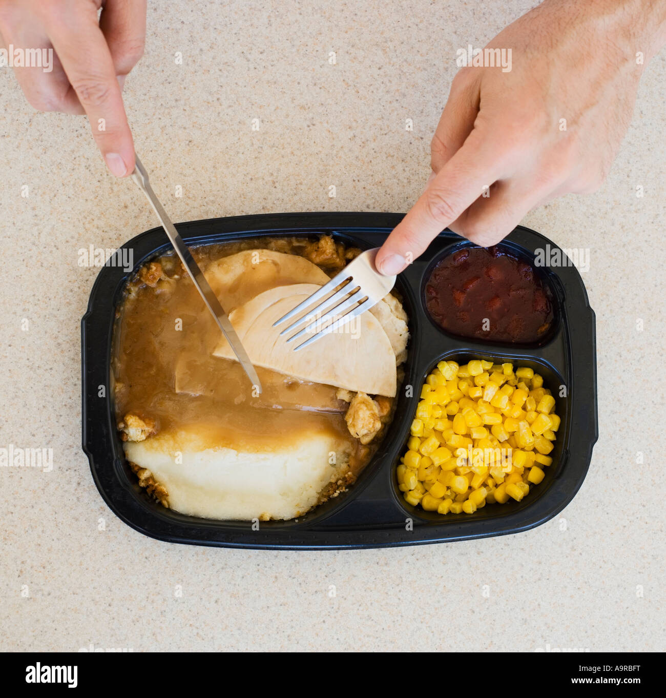 Close up of man eating TV dinner Stock Photo - Alamy
