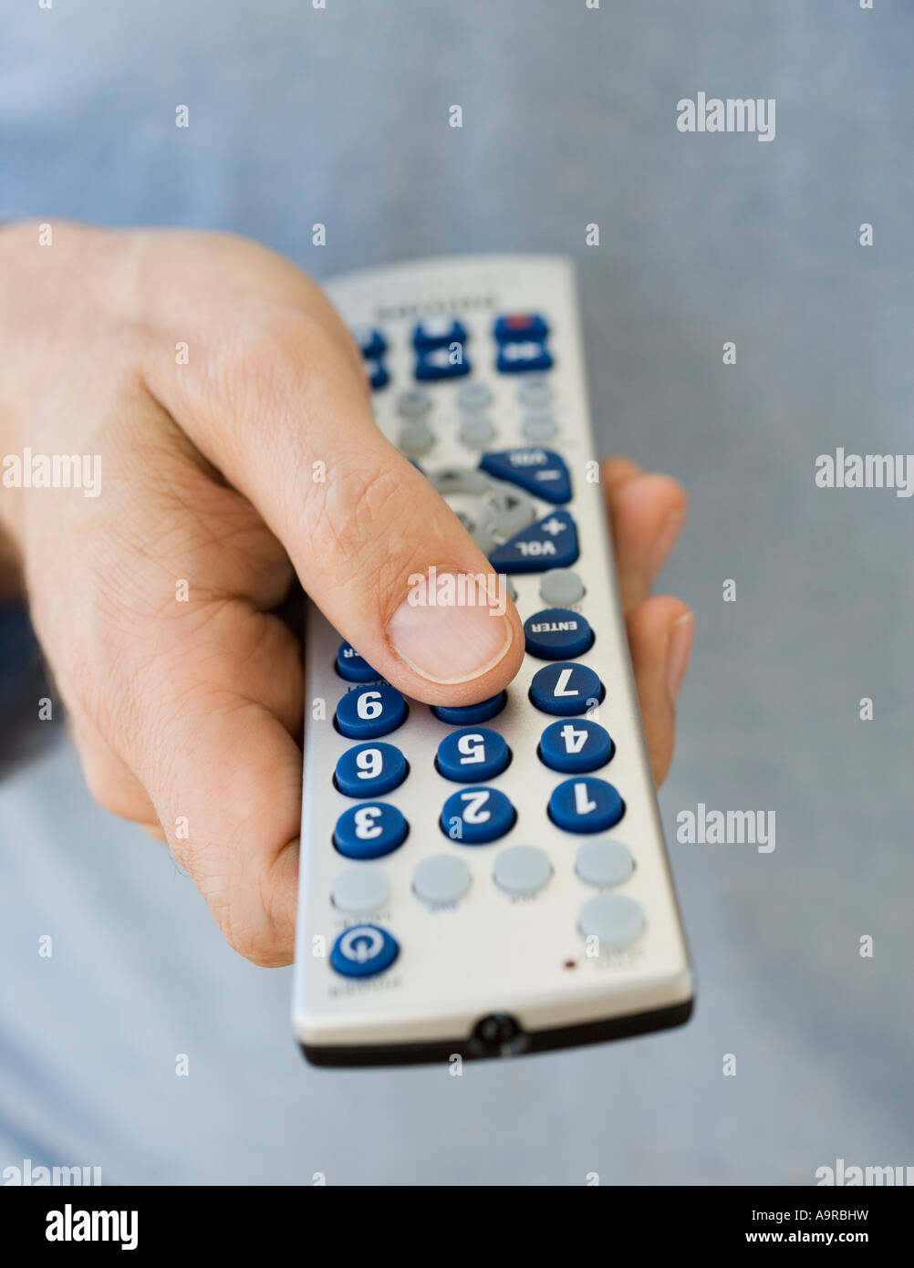 Man holding remote control Stock Photo - Alamy