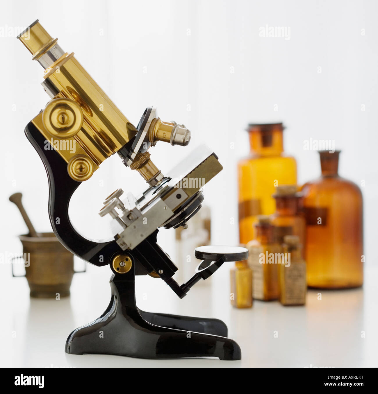 Old fashioned microscope and bottles Stock Photo - Alamy