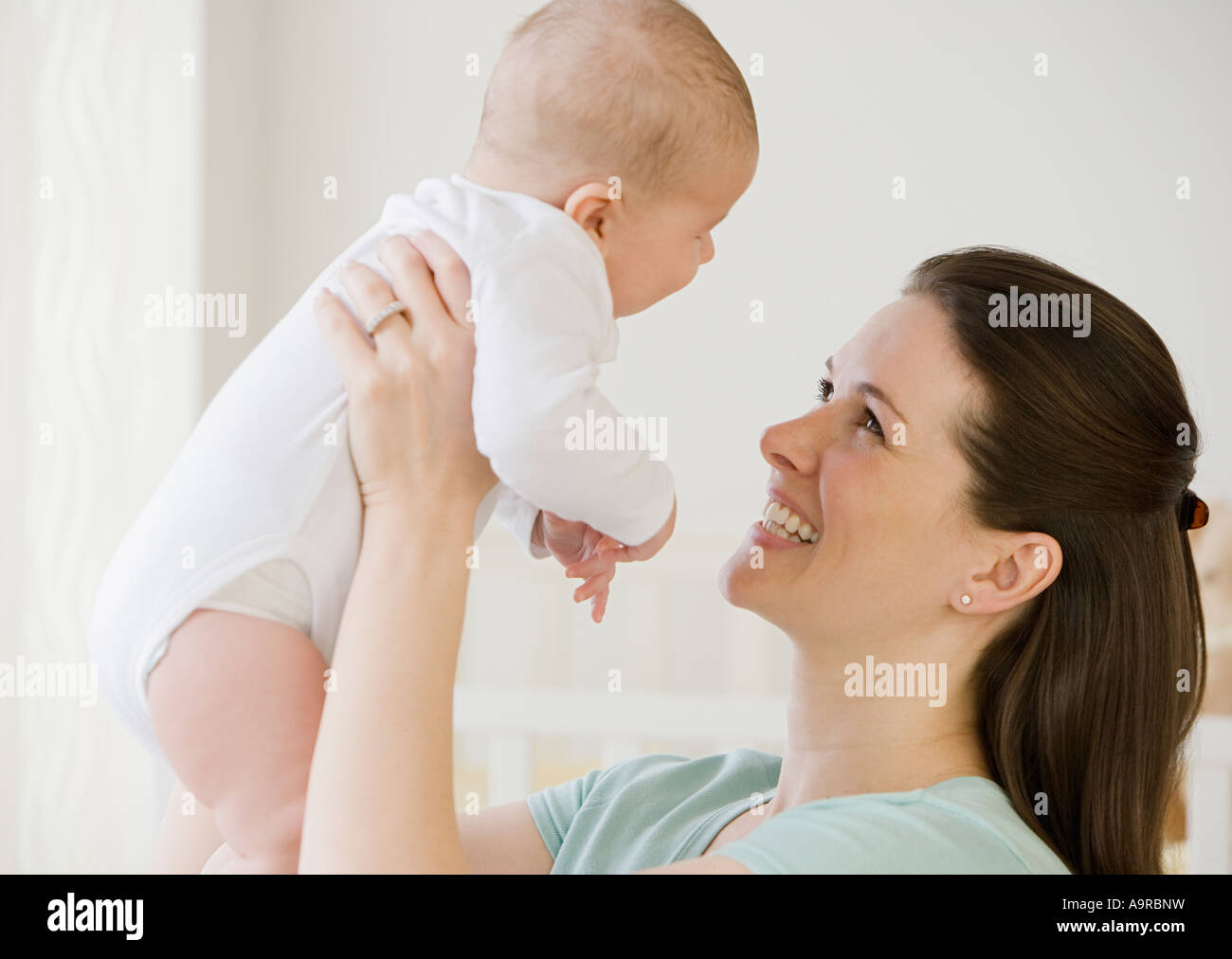 Mother smiling at baby Stock Photo - Alamy