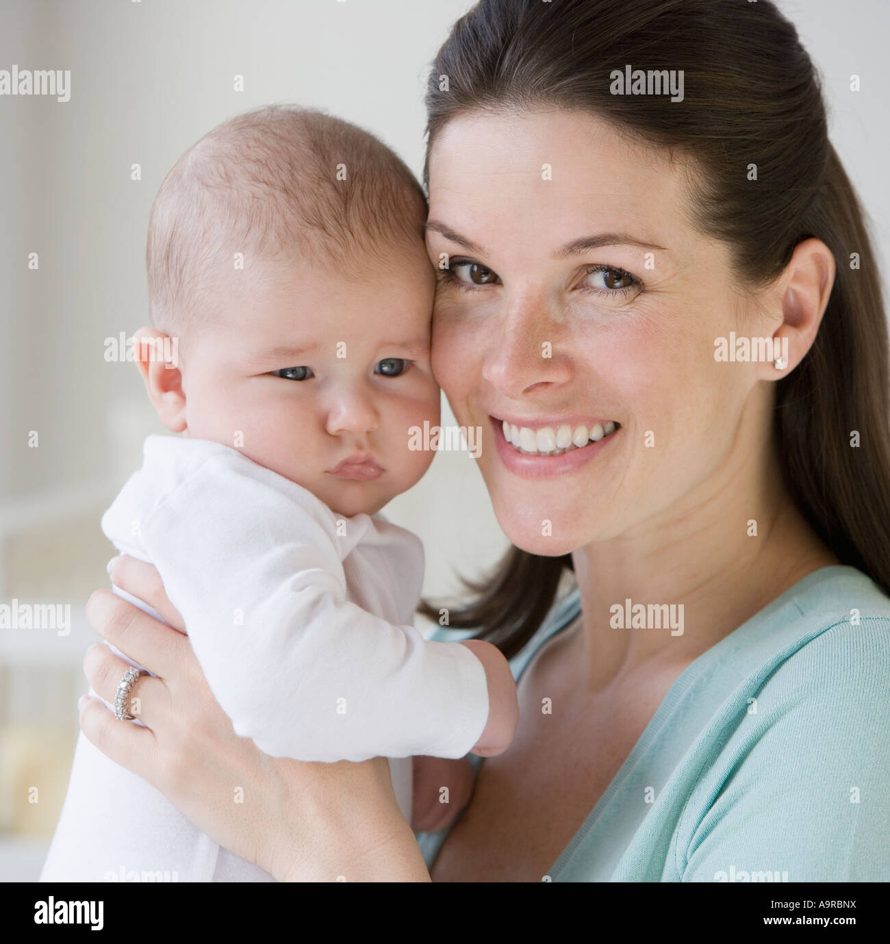 Mother hugging baby Stock Photo - Alamy