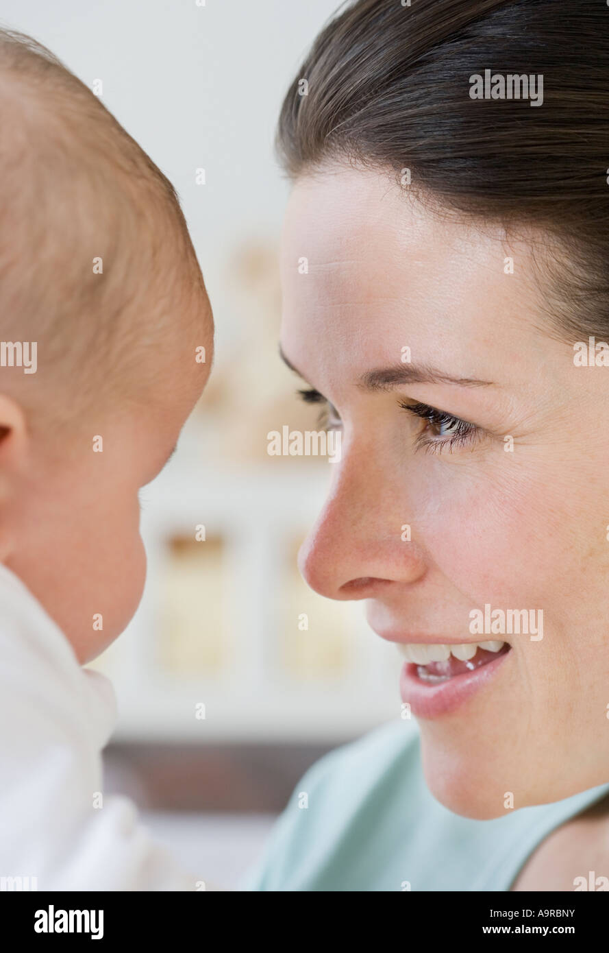 Mother smiling at baby Stock Photo - Alamy