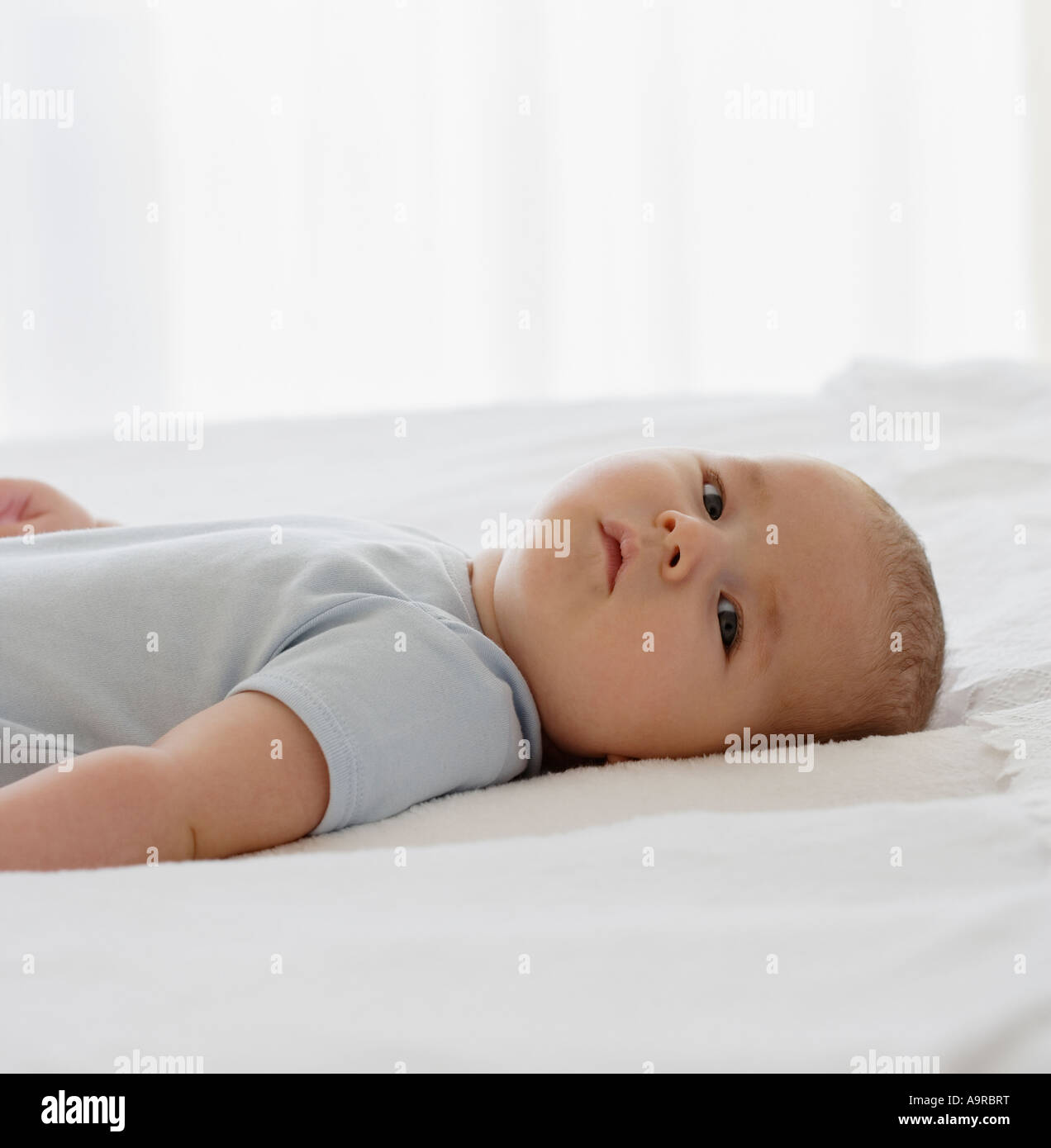 Baby laying on bed hi-res stock photography and images - Alamy