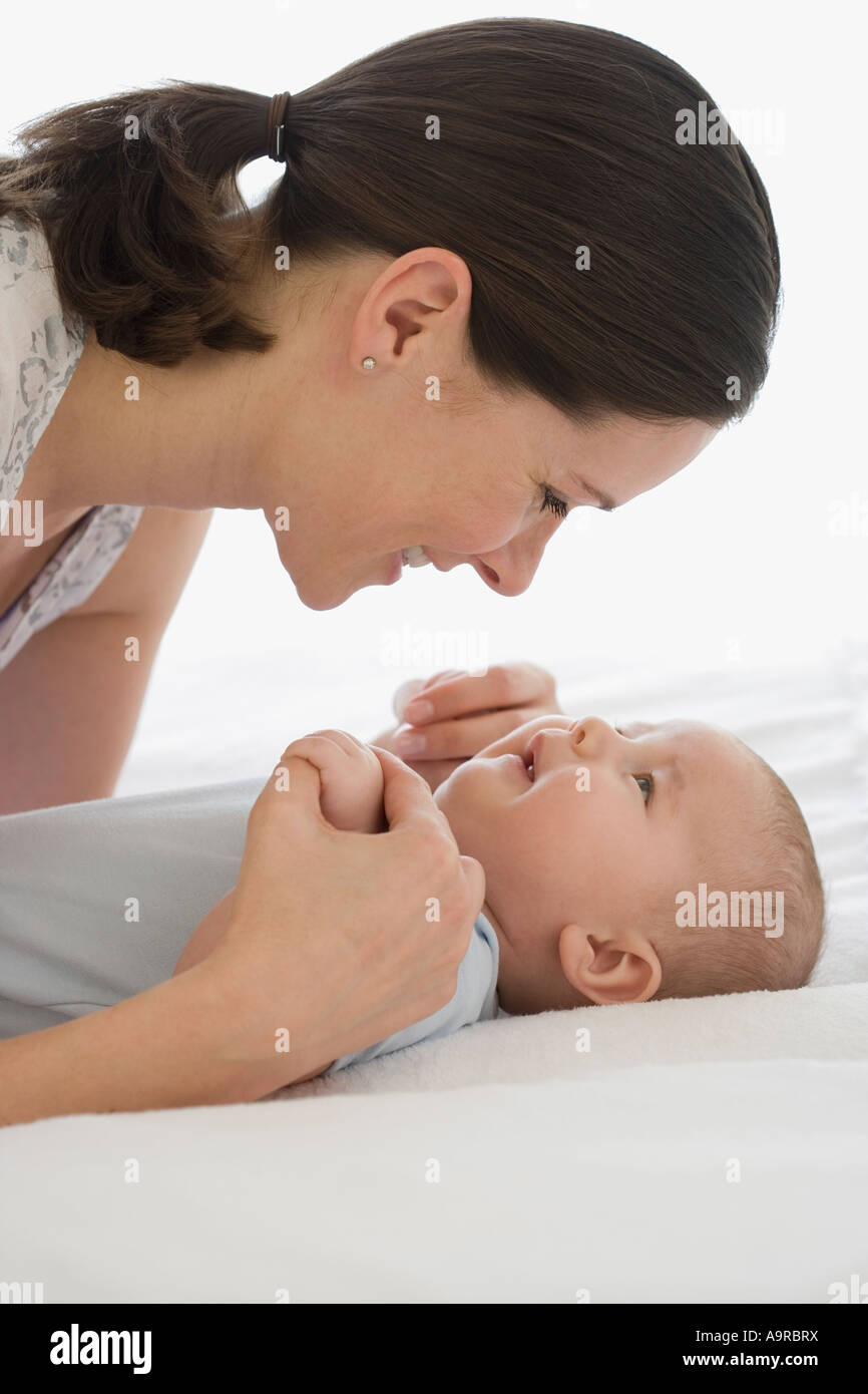 Mother smiling at baby Stock Photo - Alamy