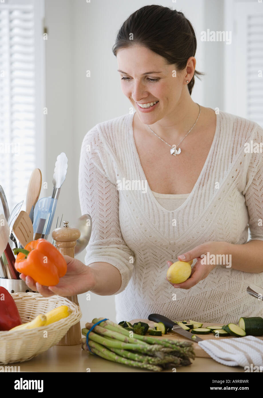Woman chopping vegetables in kitchen Stock Photo - Alamy