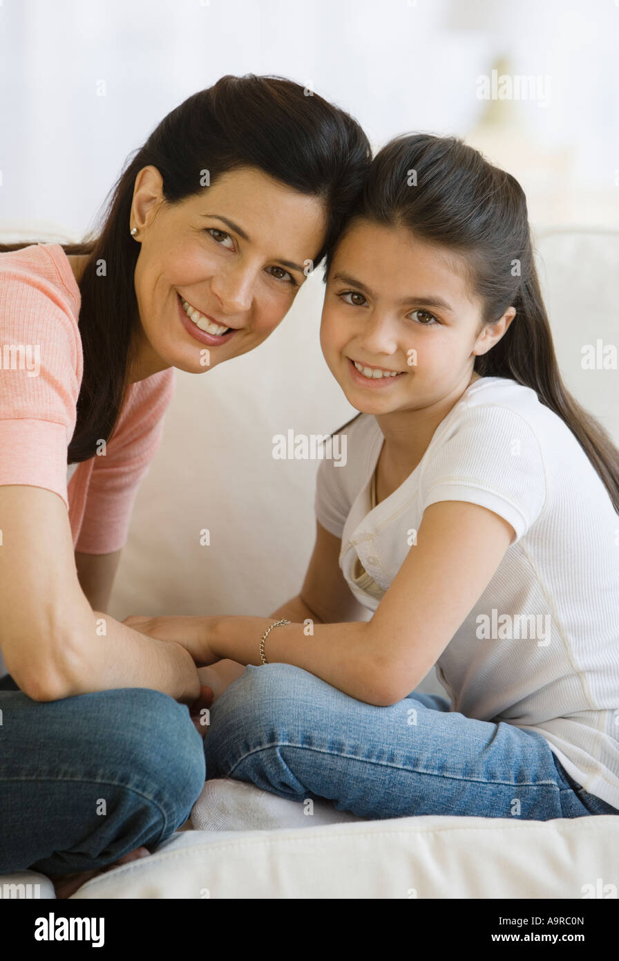 Mother and daughter touching heads Stock Photo - Alamy