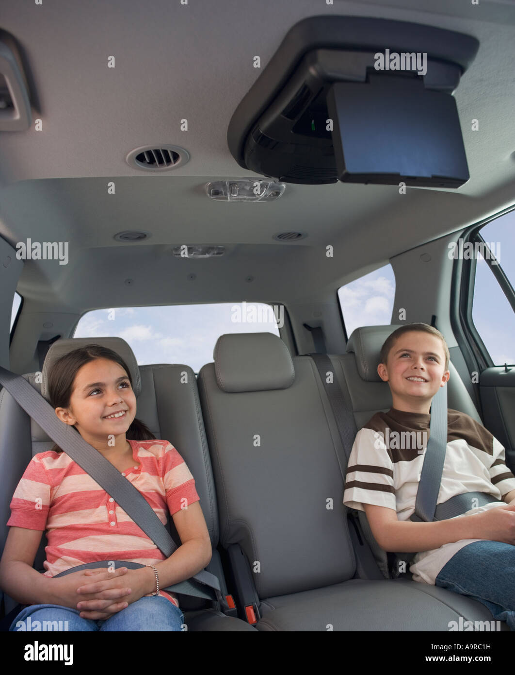 Brother and sister watching moving in car Stock Photo - Alamy