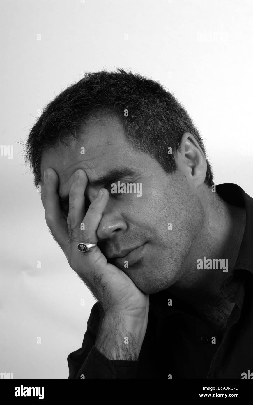Portrait of a 44 year old Turkish man with head in hand, London UK ...