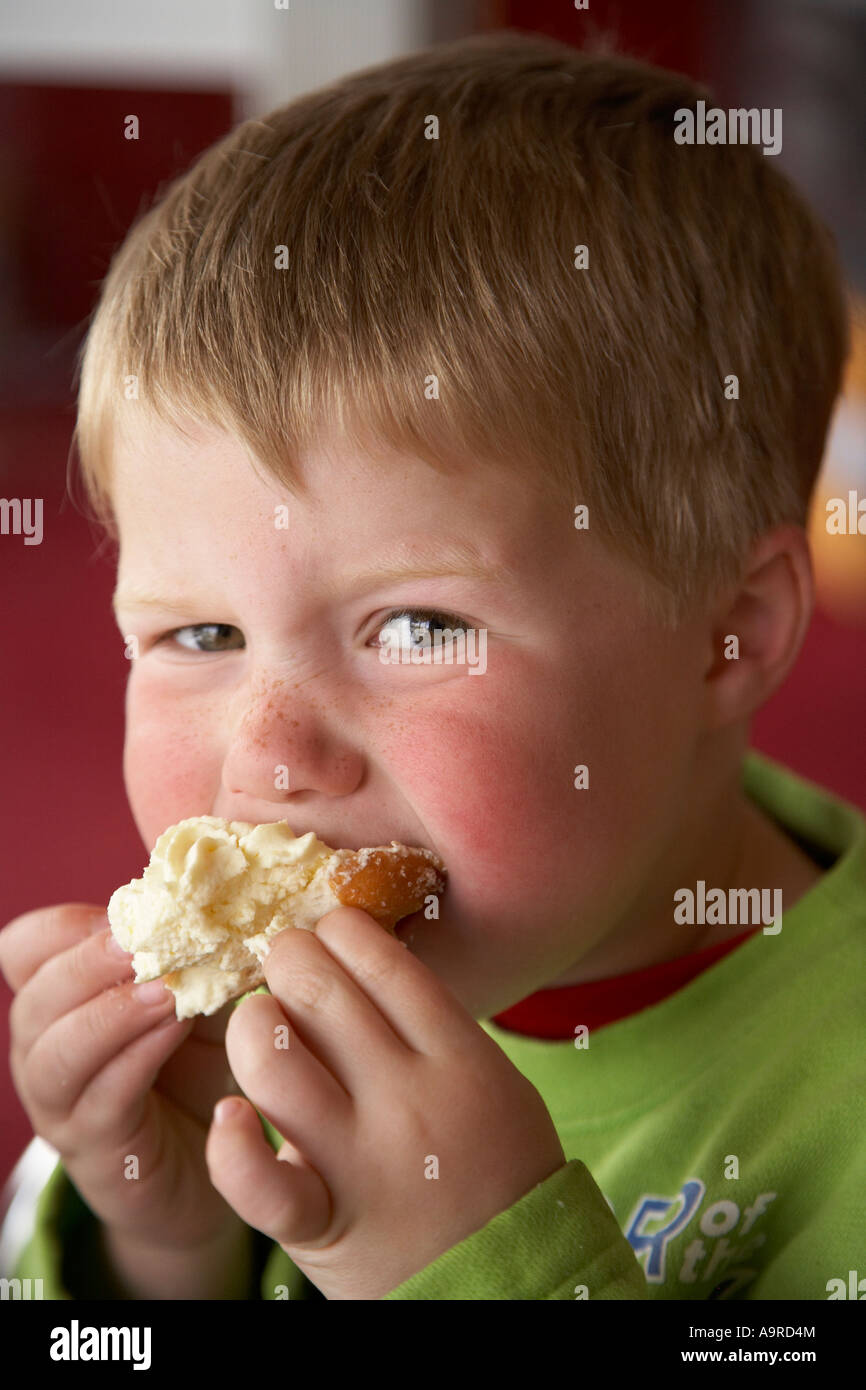 boy 4 eating cream bun Stock Photo - Alamy