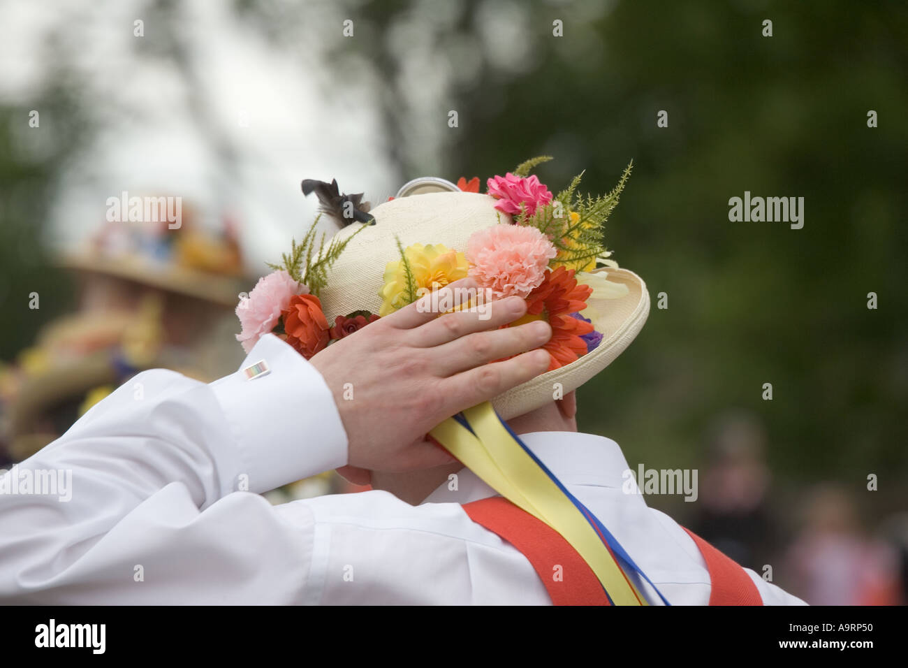 Brightly coloured floral straw hat worn by Morris dancer Bishops Cleeve ...