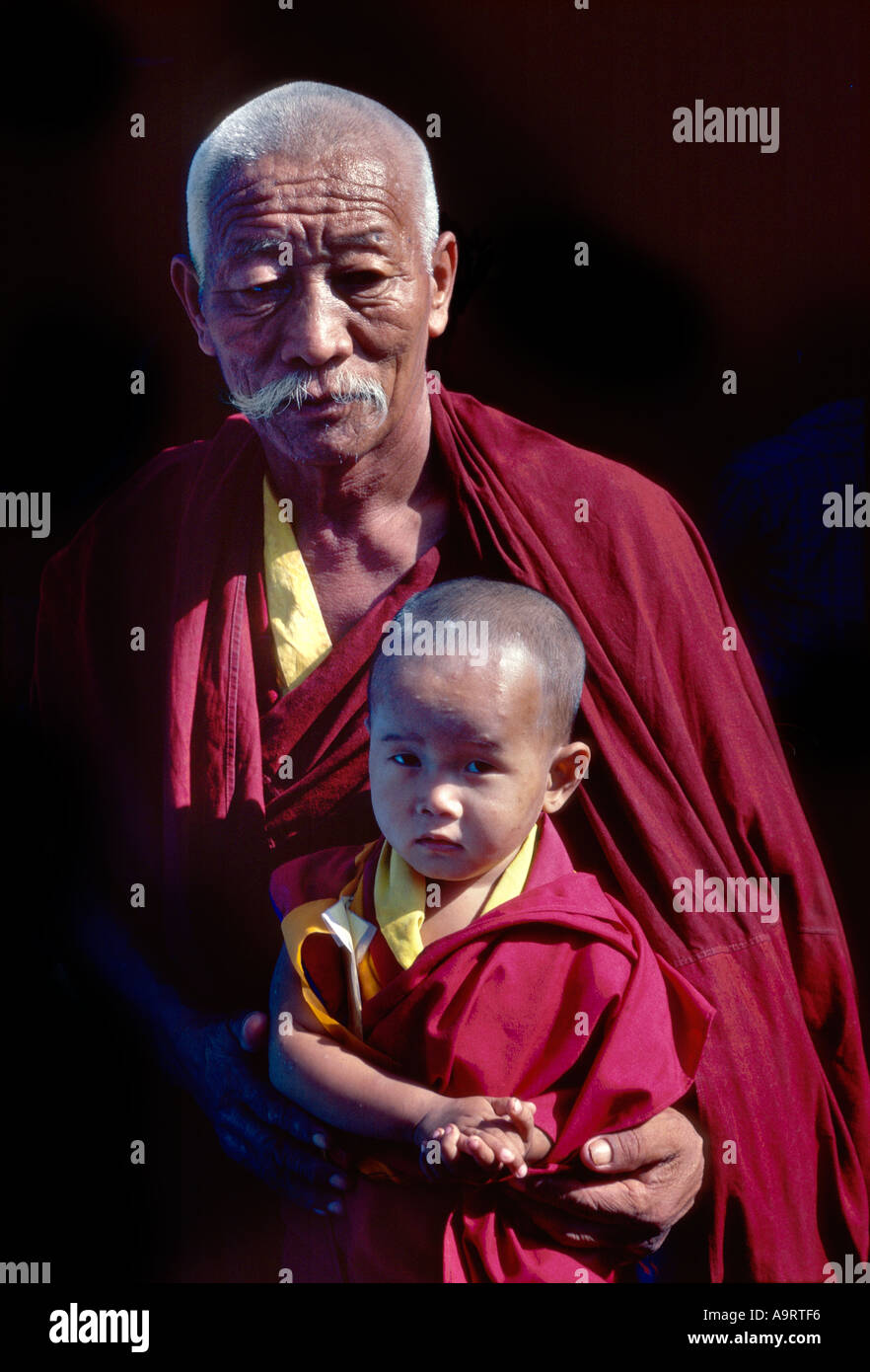 Portrait of an elderly Tibetan Buddhist monk and boy monk student ...
