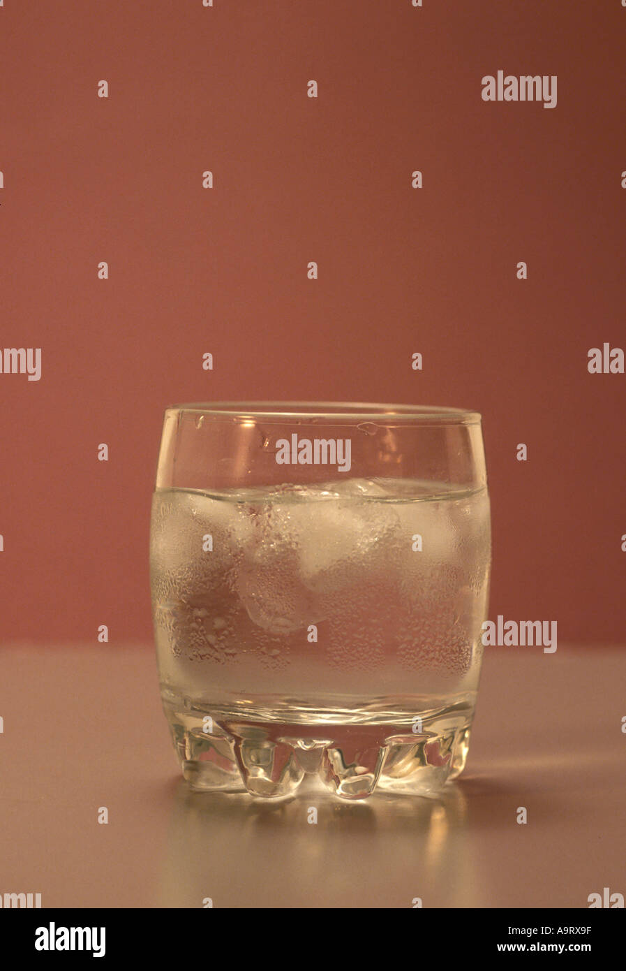 Glass half ice half water Stock Photo - Alamy