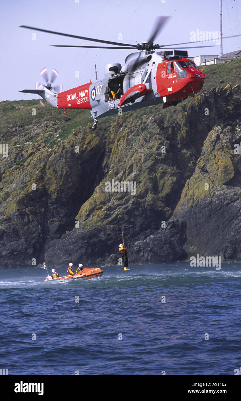 Sea rescue by helicopter and inshore R.N.L.I. lifeboat near cliffs ...