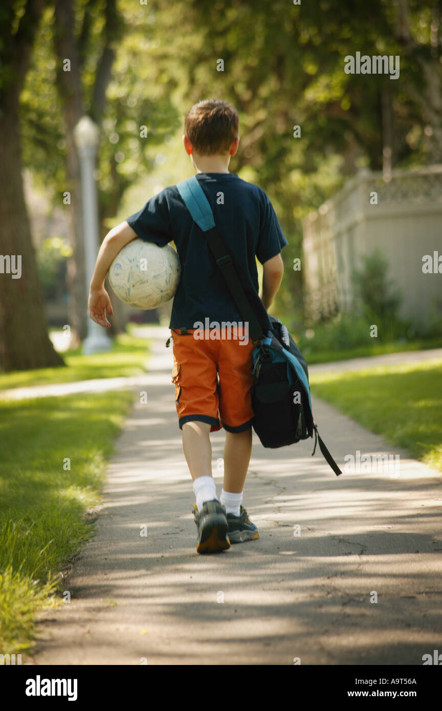 Child walks home from school Stock Photo - Alamy