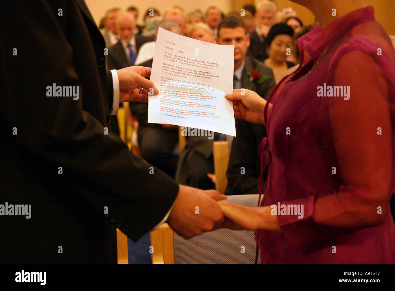 A couple read out a wedding pledge to each other and their guests after ...