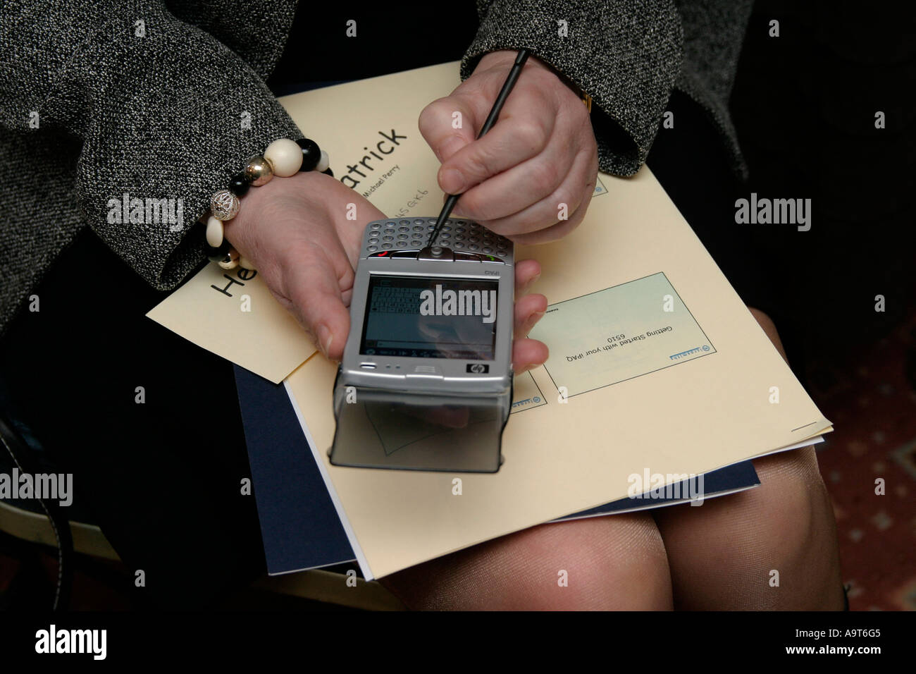 female making notes using a PDA Smartphone Stock Photo - Alamy