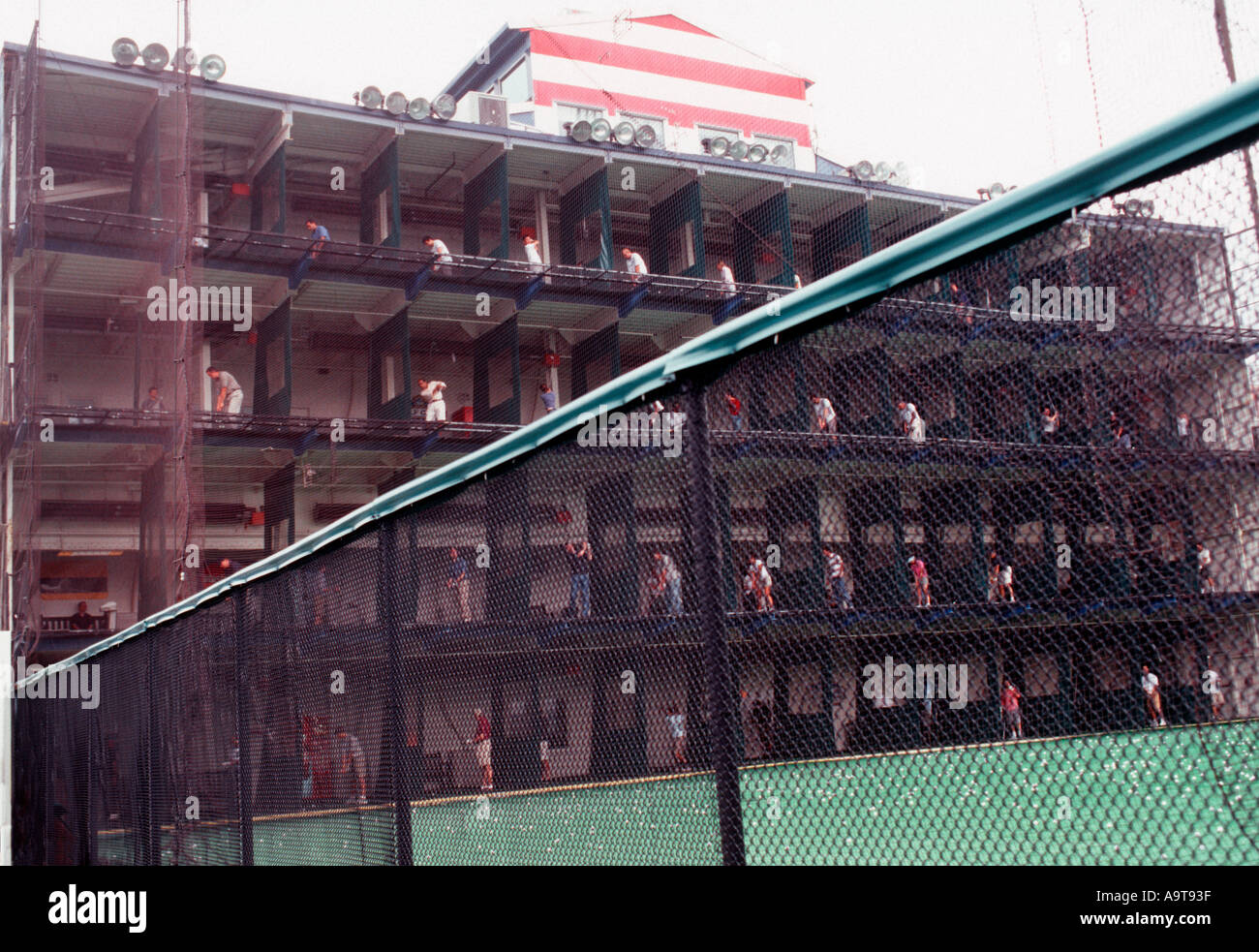 Golfers practice at the Chelsea Piers driving range Stock Photo - Alamy