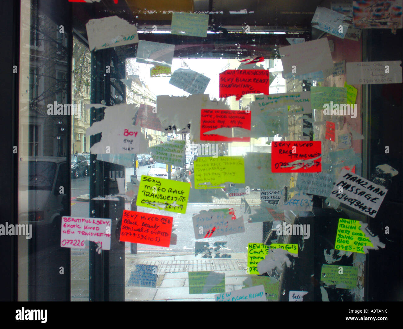 Stickers on telephone box London UK Stock Photo - Alamy