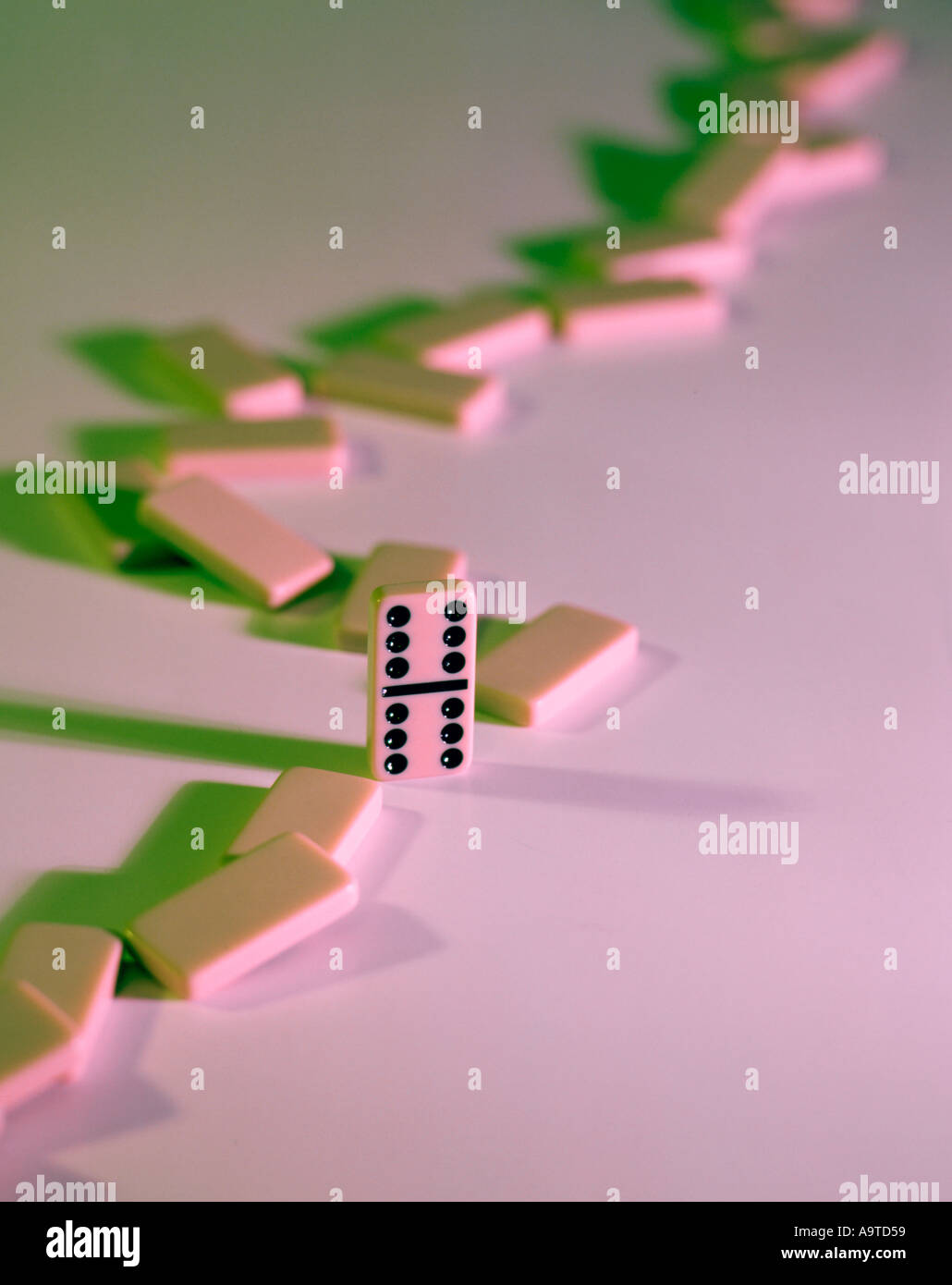 Concept Winner One domino standing Stock Photo - Alamy