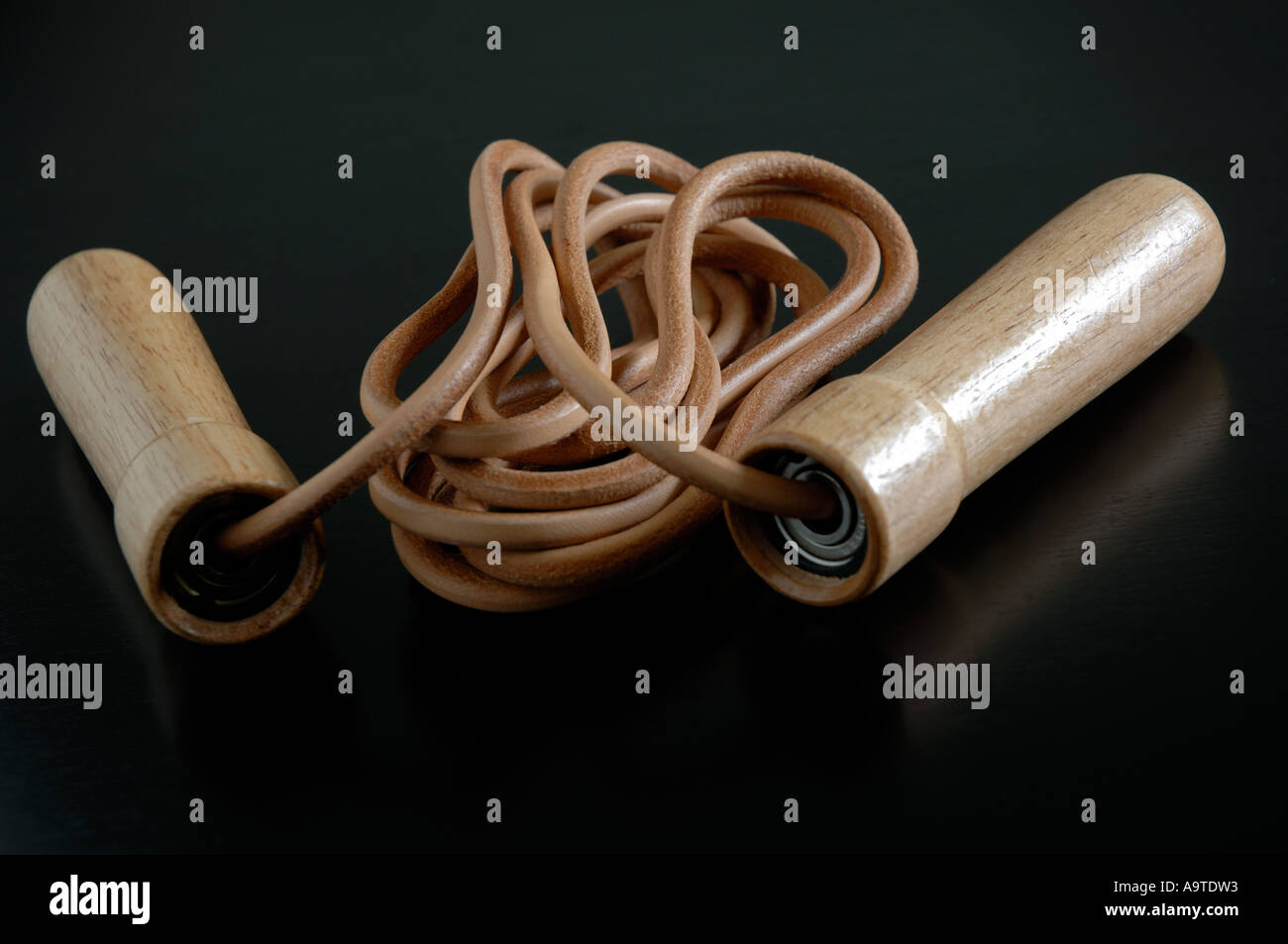 Leather jumping rope over black background Stock Photo - Alamy