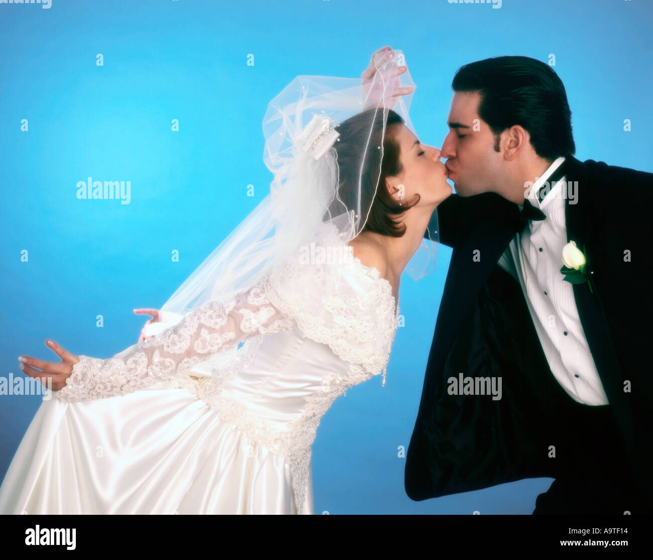 Wedding couple kissing Stock Photo - Alamy