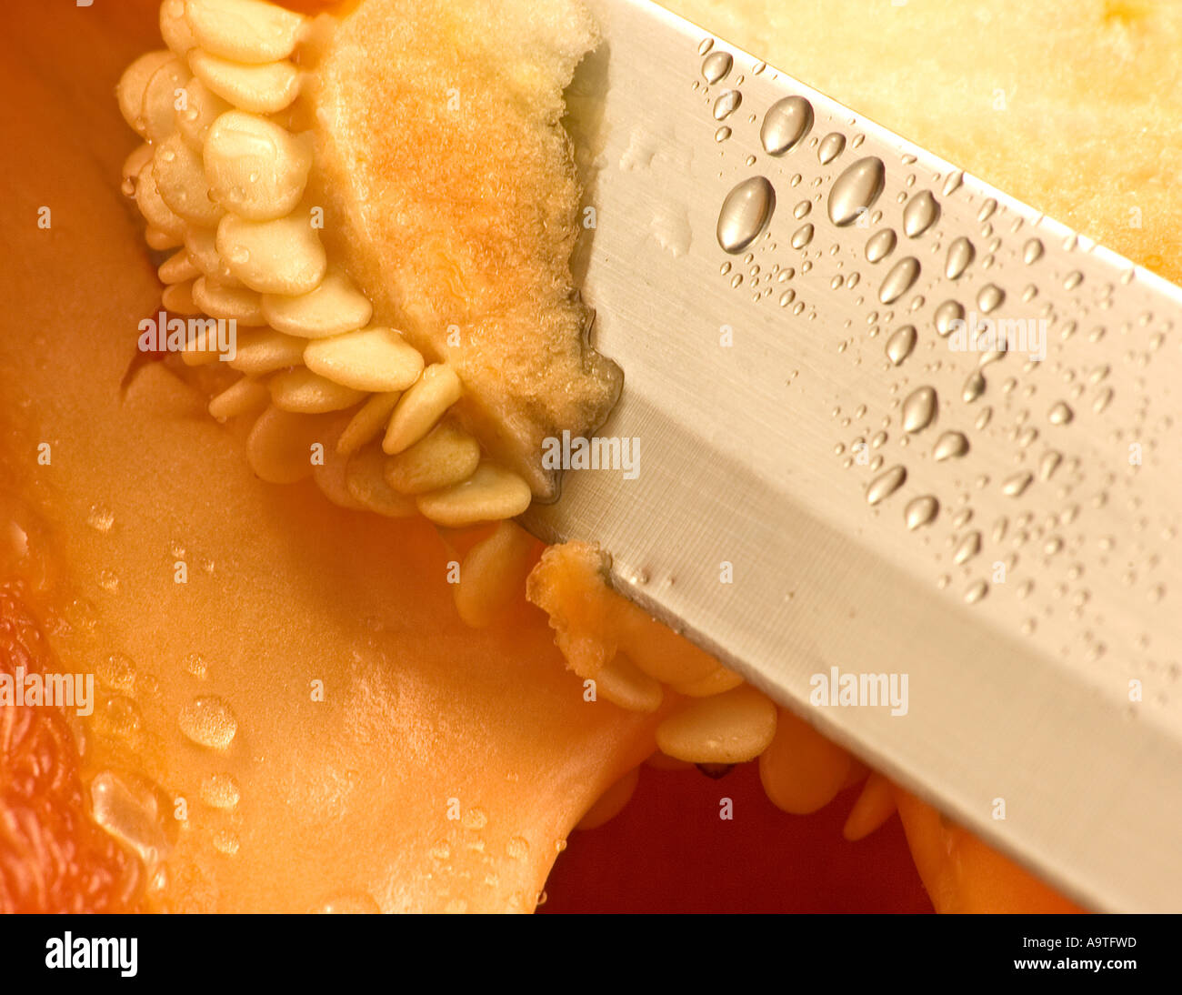 Knife cutting through pepper Stock Photo - Alamy
